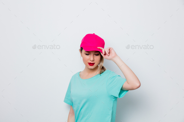 Beautiful young girl in cap and t-shirt Stock Photo by Masson-Simon