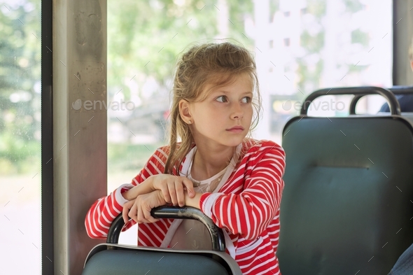 Child passenger of city bus, trolleybus, girl sitting in passenger seat ...