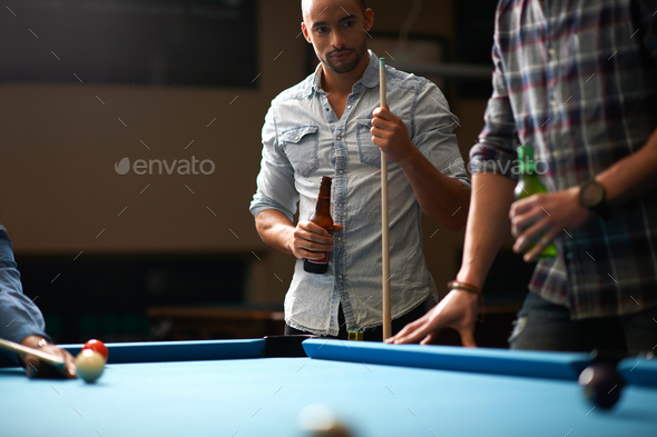 Men with beer standing at pool table Stock Photo by imagesourcecurated