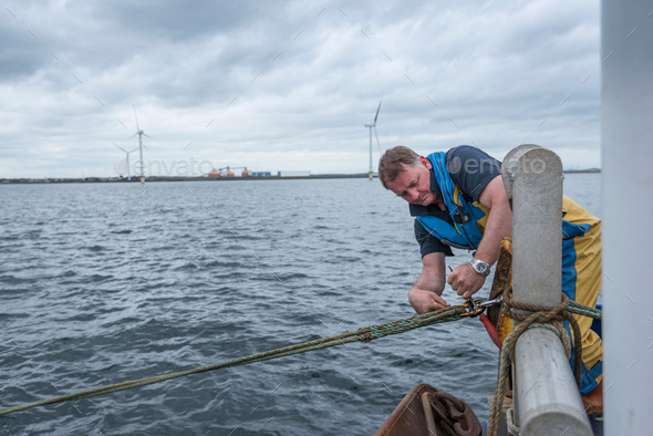 Fisherman tightening trawl line on research ship Stock Photo by ...
