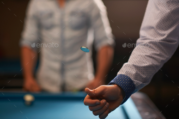 Man tossing coin at pool table Stock Photo by imagesourcecurated ...
