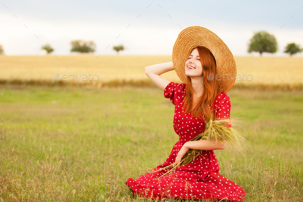 Redhead girl in red dress at wheat field Stock Photo by Masson-Simon