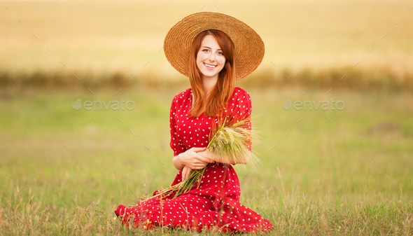 Redhead girl in red dress at wheat field Stock Photo by Masson-Simon