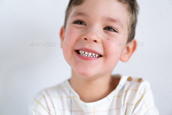 Portrait of a cute boy smiling with white healthy teeth. Emotions of a ...