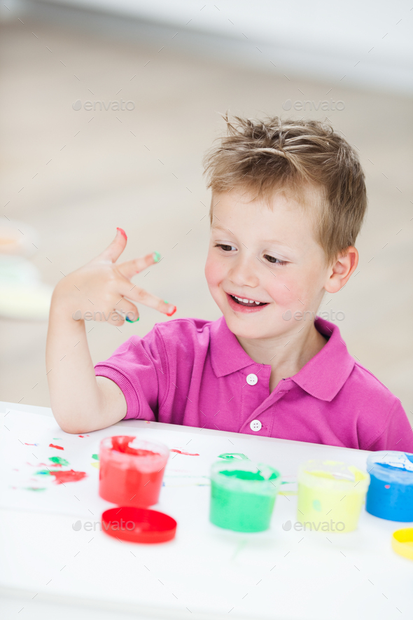 young boy playing with colours Stock Photo by ImageSourceCur | PhotoDune