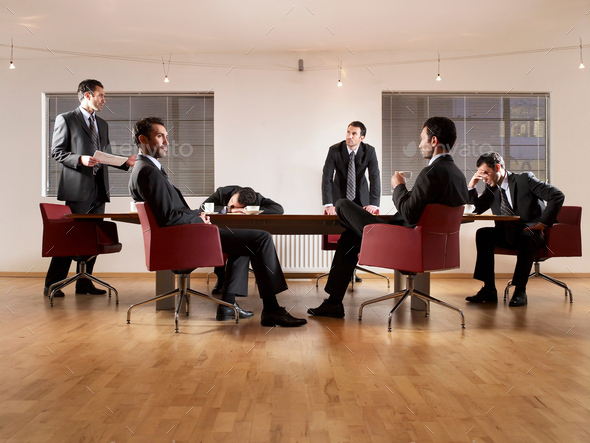 Businessmen at boardroom table Stock Photo by nualaimages | PhotoDune