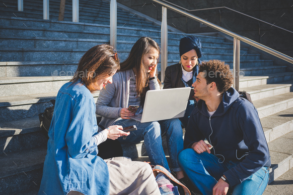 Multiracial group young people using technology Stock Photo by peus80