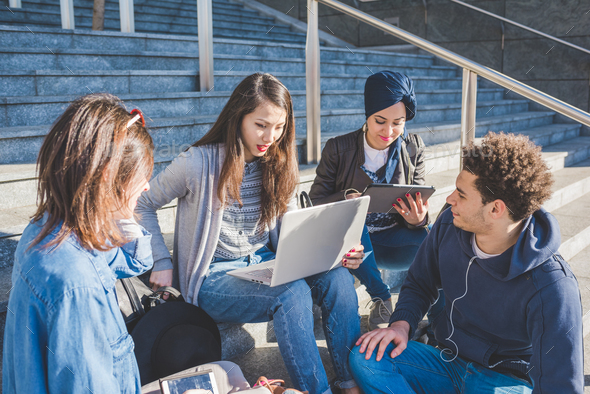 Multiracial group young people using technology Stock Photo by peus80
