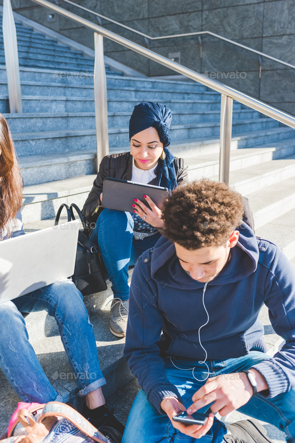 Multiracial group young people using technology Stock Photo by peus80