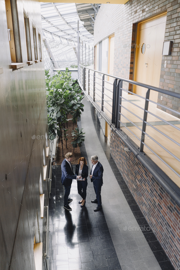 Business people talking in modern office building Stock Photo by westend61