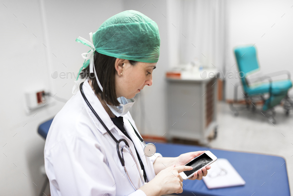 Doctor using smartphone Stock Photo by westend61 | PhotoDune