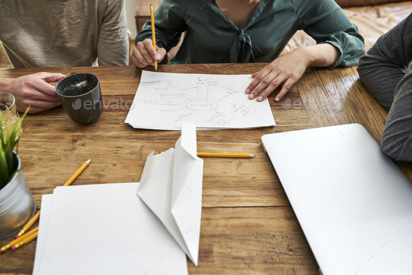 Coworkers working together and taking notes at table in office Stock ...
