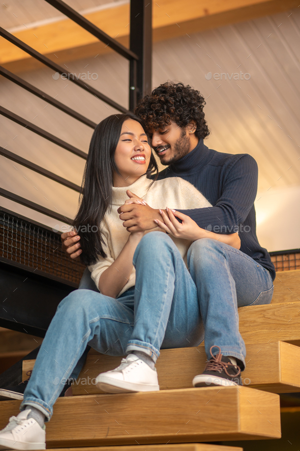 Man hugging woman sitting on stairs Stock Photo by Zinkevych_D | PhotoDune