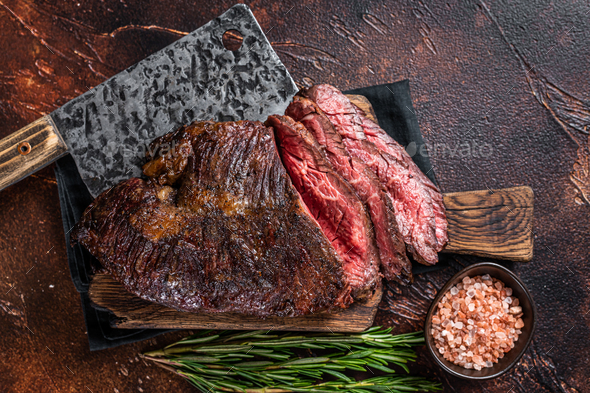 Roasted hanging tender or Onglet sliced beef meat steak on a butcher ...
