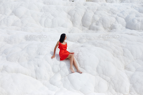 Girl in red dress on white travertines, Pamukkale Stock Photo by IvaFoto