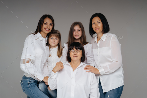 Women of three generations posing on gray Stock Photo by diignat ...
