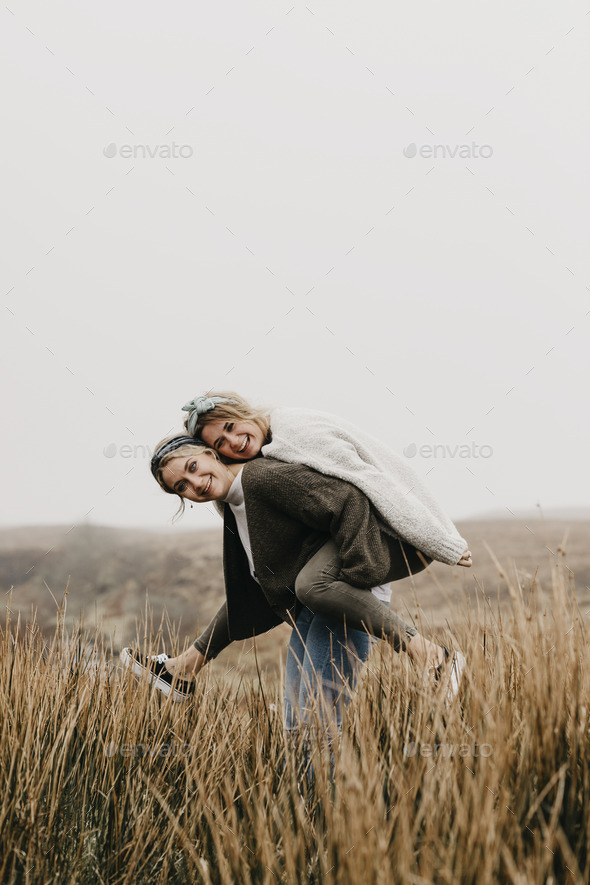 UK, Scotland, Isle of Skye, happy woman carrying friend piggyback in ...