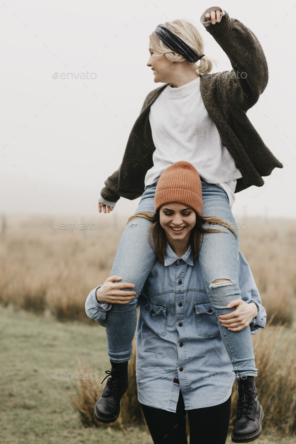 UK, Scotland, Isle of Skye, happy woman carrying friend piggyback in ...