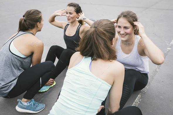 Four women having an outdoor boot camp workout Stock Photo by westend61