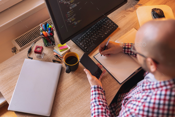 Programmer working in home office Stock Photo by Impactphotography