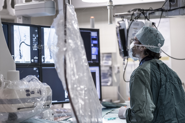 Neuroradiologist in scrubs during operation Stock Photo by westend61