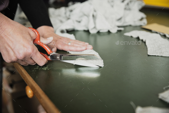 Close up of woman's hand cutting a fabric with scissor Stock Photo by ...