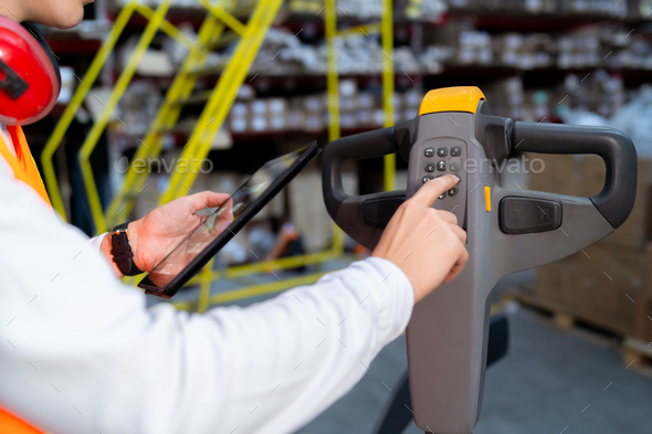 Operator of the pallet loading machine makes the setting Stock Photo by ...
