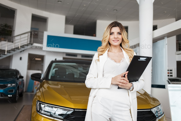 Car sales woman agent at a car dealership Stock Photo by borodai ...