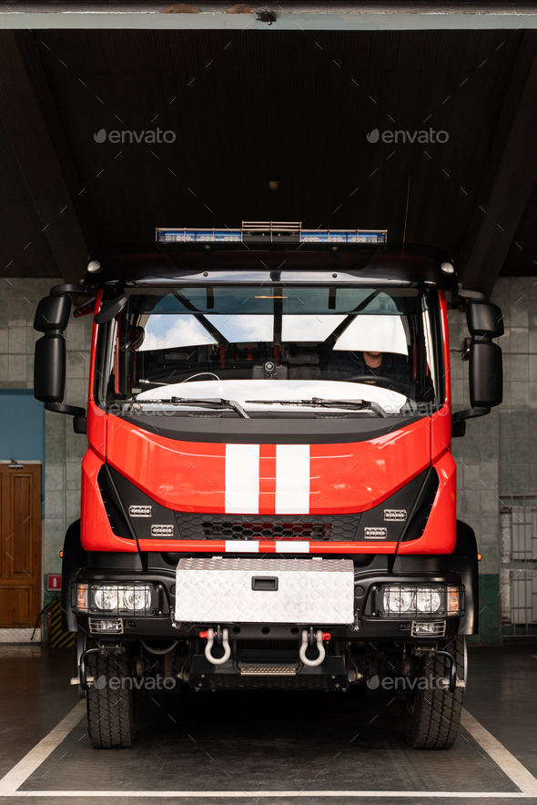 Full length view of the big red fire engine standing at the garage. Red ...