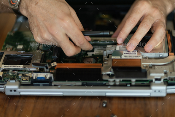 Laptop repair. Disassembled computer parts. Stock Photo by Pasanheco