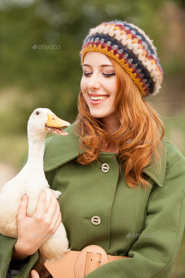 photo of beautiful young woman with goose on the wonderful trees ...
