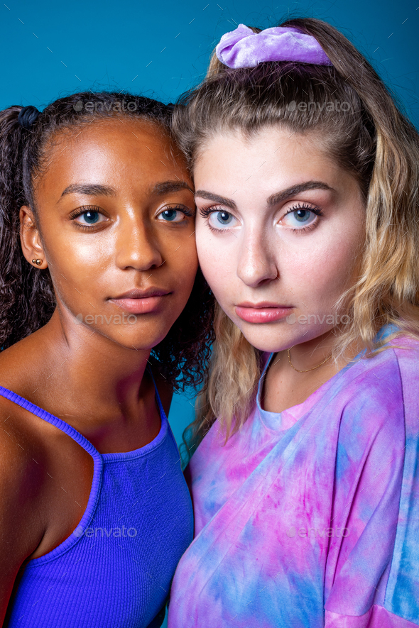 Confident diverse female models standing close and looking at camera ...