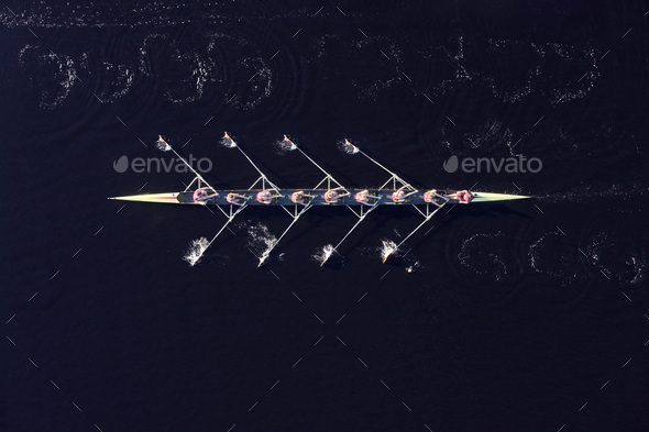 Elevated view of female's rowing eight in water Stock Photo by westend61