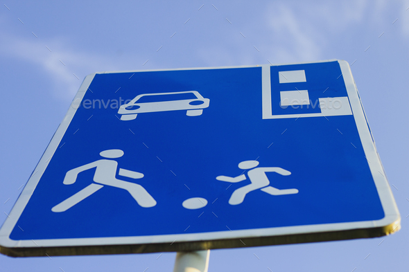 Information road sign, blue rectangular shield with human figures, car ...