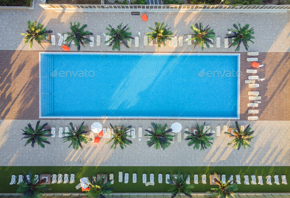 Top down aerial view of hotel swimming pool with crystal blue water ...