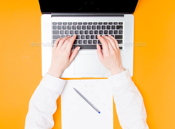 Businesswoman making notes with laptop and paper Stock Photo by Masson ...