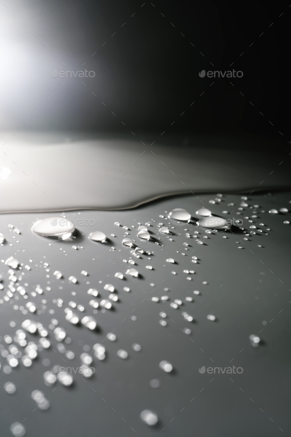 Falling water drops on a shadow background. Stock Photo by marevgenna1985