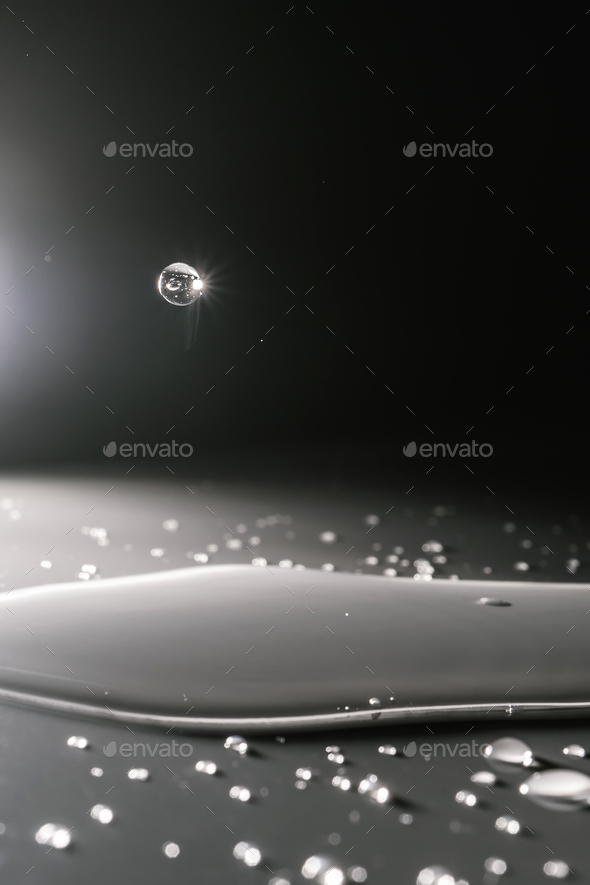 Falling water drops on a shadow background. Stock Photo by marevgenna1985