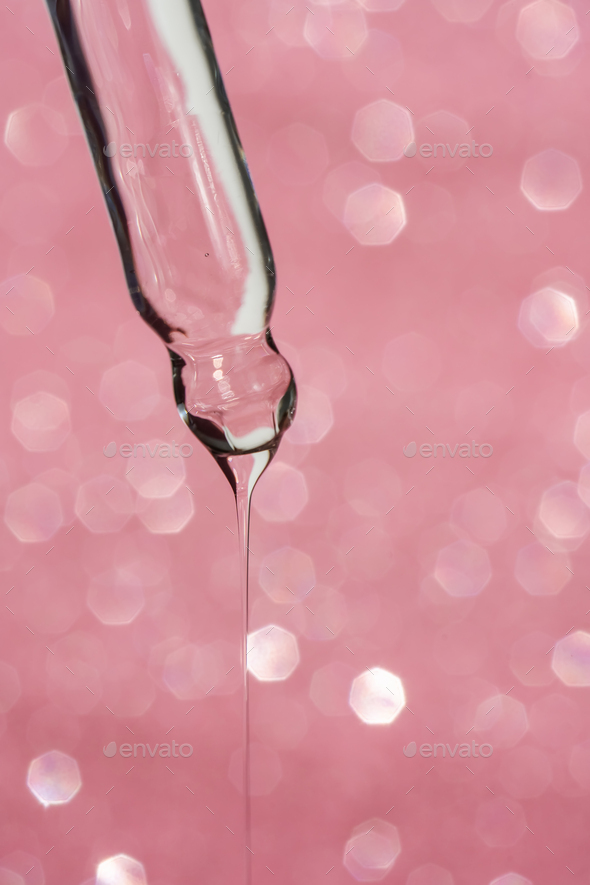 Cosmetic pipette with a drop on pink background. Stock Photo by ...