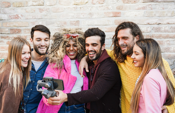 Happy influencer friends having fun vlogging with gimbal and mobile ...