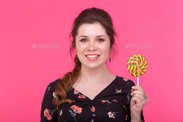Candy, addiction to sweet and emotions concept - happy woman with ...