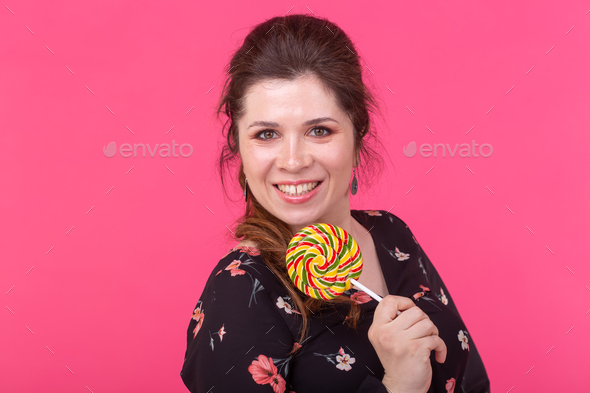 Candy, addiction to sweet and emotions concept - happy woman with ...