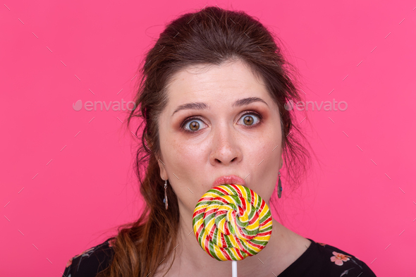 Candy, addiction to sweet and emotions concept - surprised woman with ...