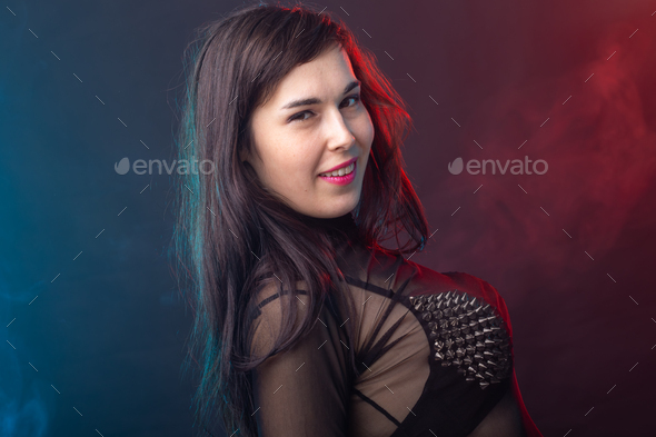 Alluring young beautiful brunette woman in a provocative dress posing ...