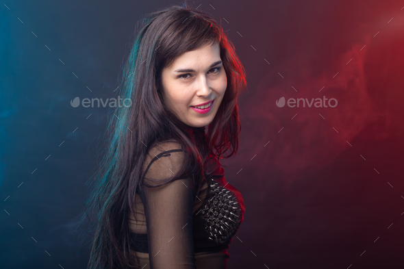 Alluring young beautiful brunette woman in a provocative dress posing ...