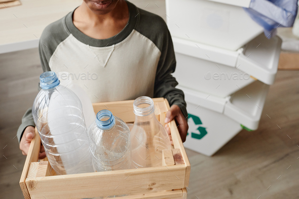 Boy Holding Plastic Bottles for Recycling Stock Photo by seventyfourimages