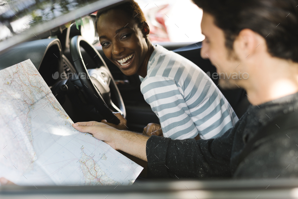 Using a map in a car for a direction Stock Photo by Rawpixel | PhotoDune