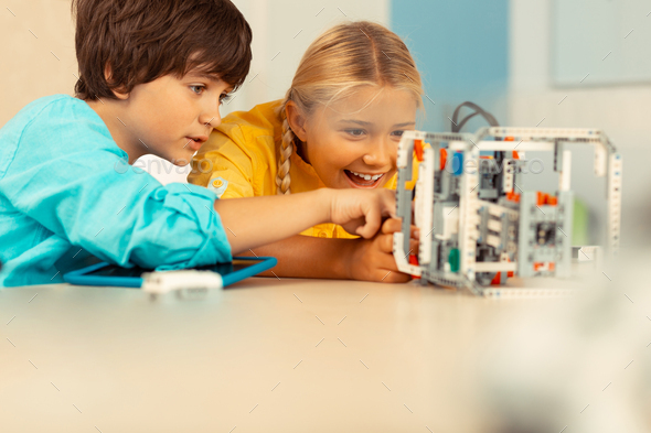 Excited children playing with the robot at science class Stock Photo by ...