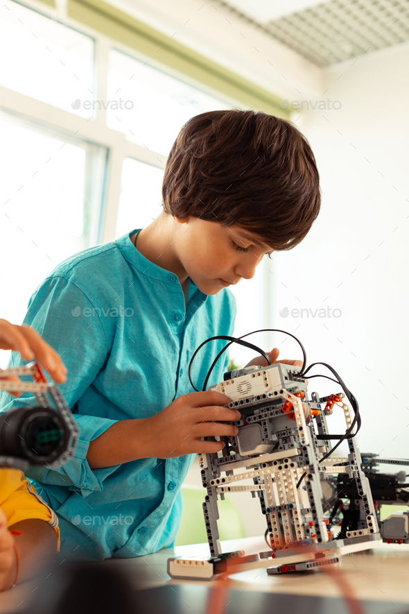 Concentrated schoolboy checking his complicated science project Stock ...