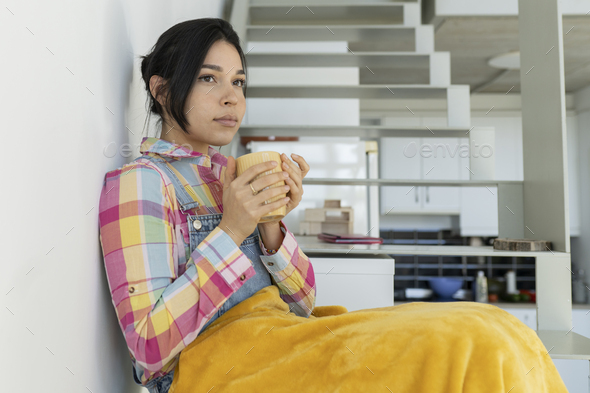 Beautiful Latino Hispanic woman resting and drinking tea sitting on the ...